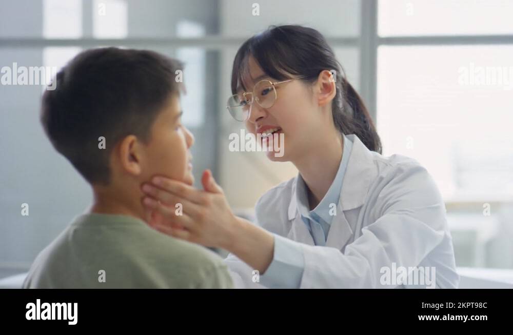 Asian Female Doctor Giving Health Checkup to Tween Boy Stock Video ...