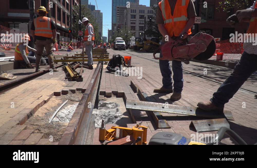 A construction worker gets ready to cut a steel beam while other ...
