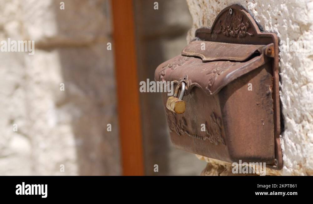 Antique iron mailbox next to the modern front door. Intercom and ...
