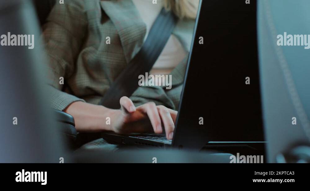 Unrecognisable business woman working on Laptop while sitting on back ...