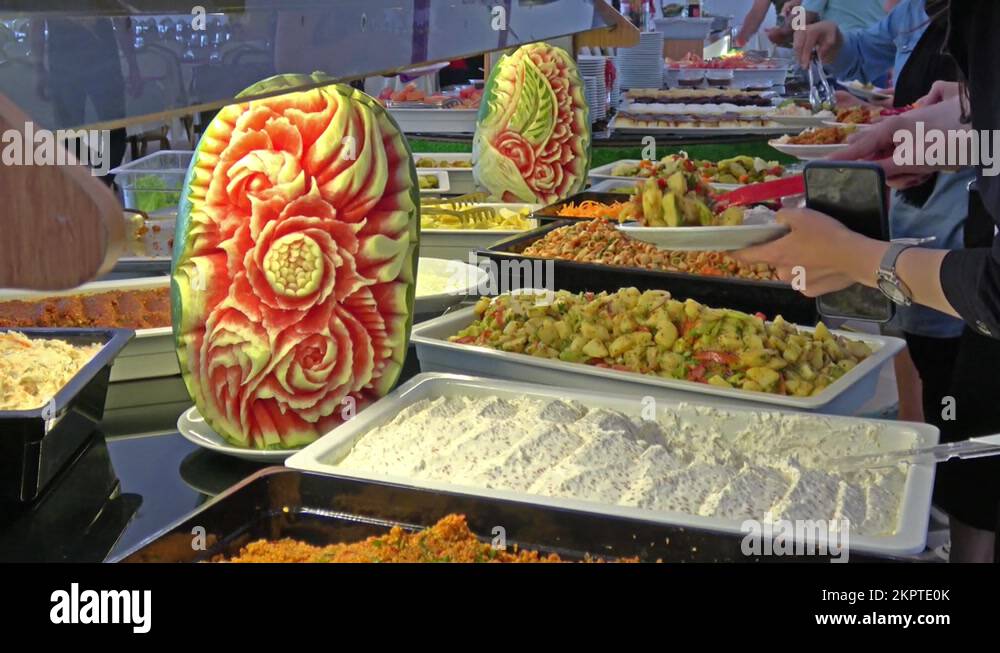 People are filling in their plates at the buffet cold table Stock Video ...