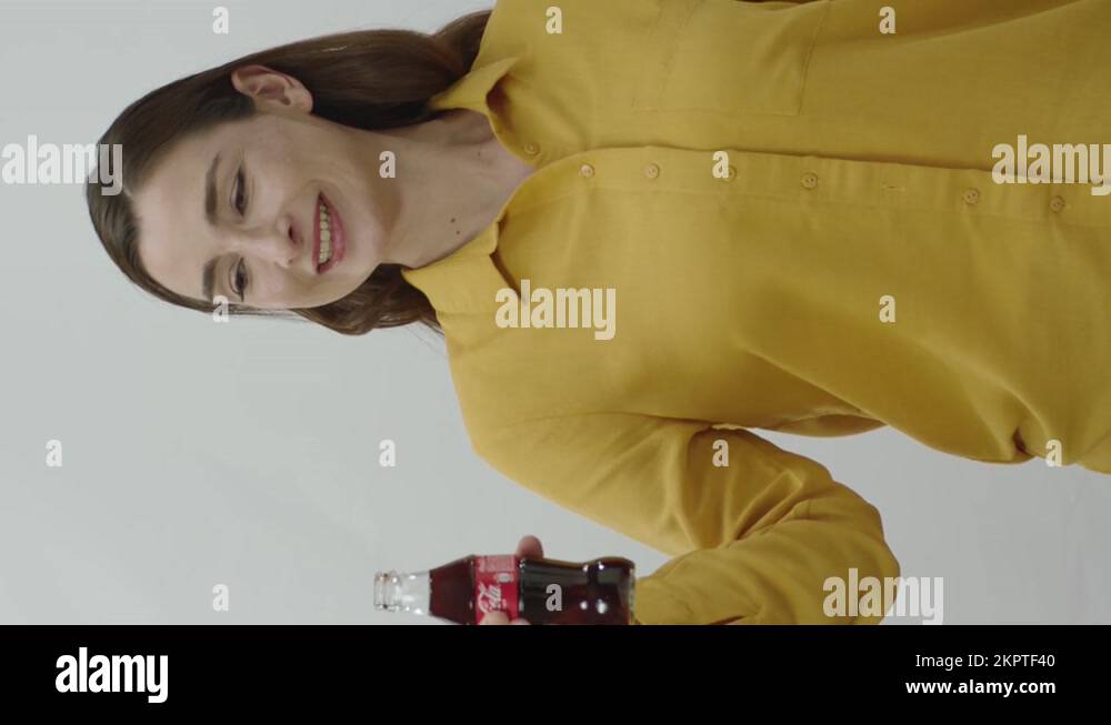 Character portrait of a young woman drinking Coca Cola from a glass ...