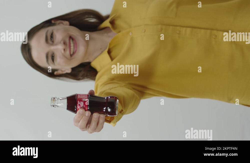 Character portrait of a young woman drinking Coca Cola from a glass ...