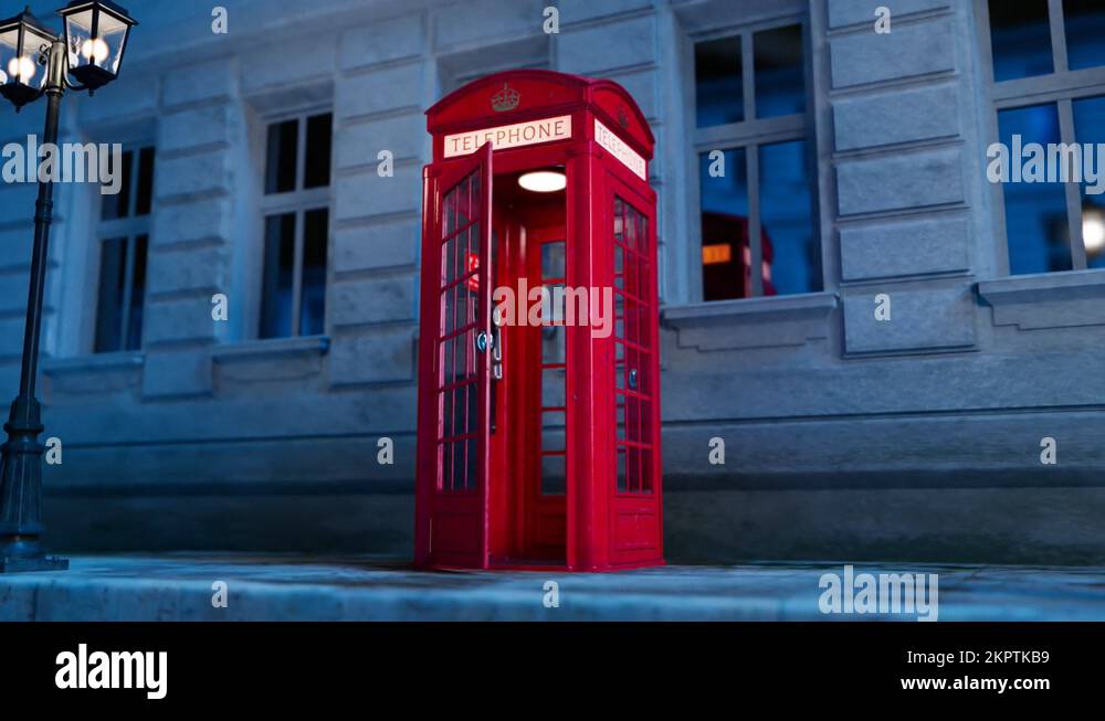 Red British phone booth with a hanging receiver on the wall. London ...