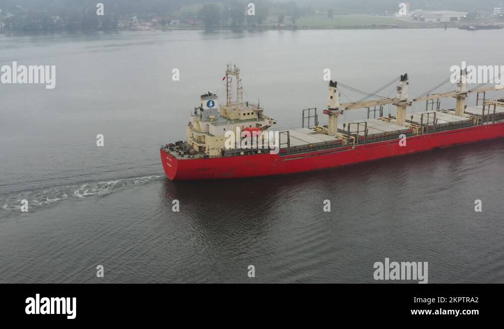 International cargo ship unloaded, slow sailing on the sea leaving the ...