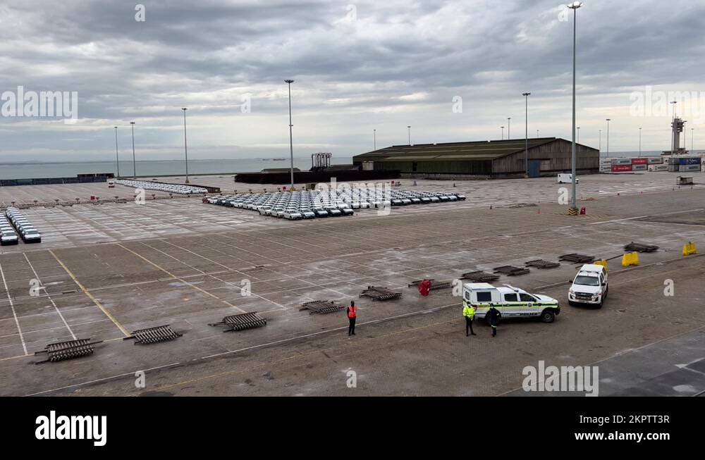Police officers on duty at Port Elizabeth harbor on the pier with cars ...