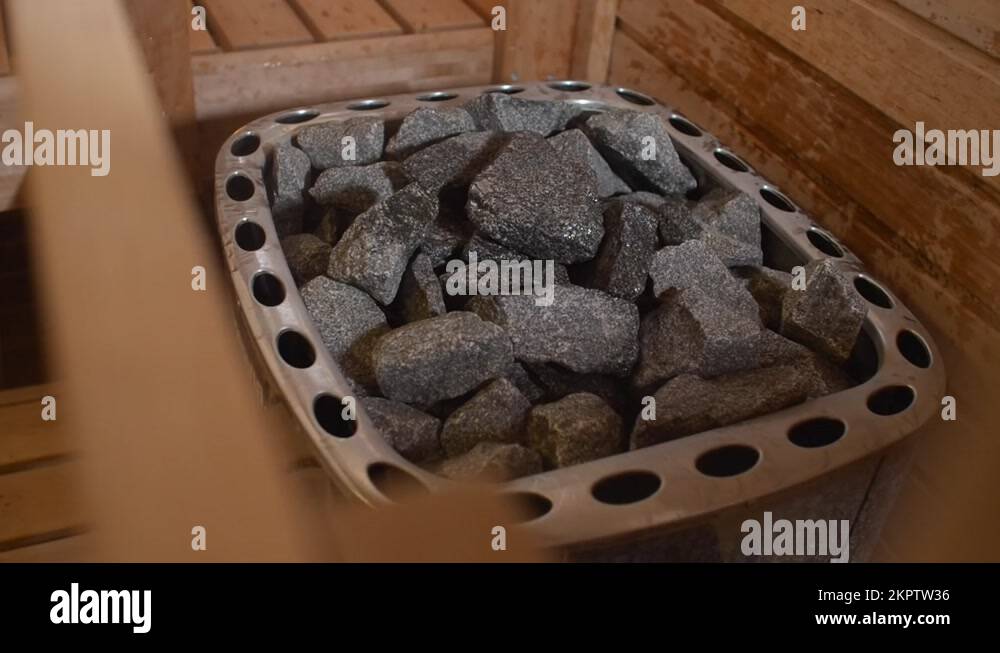 Splashed water evaporates from hot granite rocks in sauna stove Stock ...