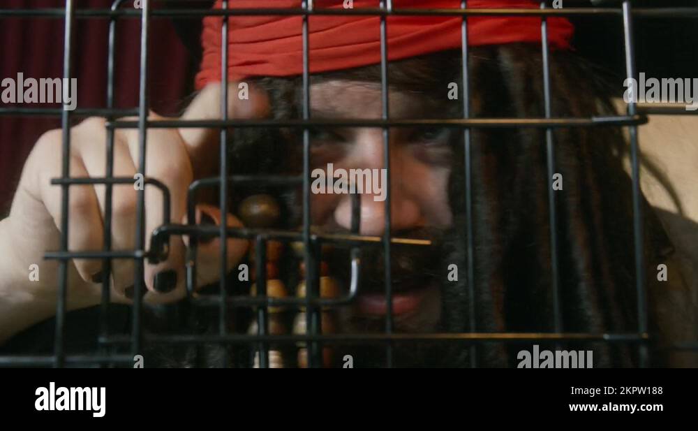 Impudent pirate mocks someone in captivity, makes faces, furiously ...