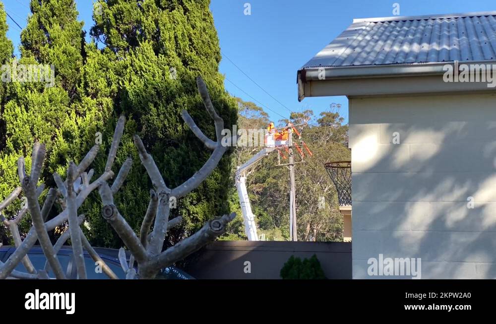 Men working on electrical cables at height using an elevated work ...