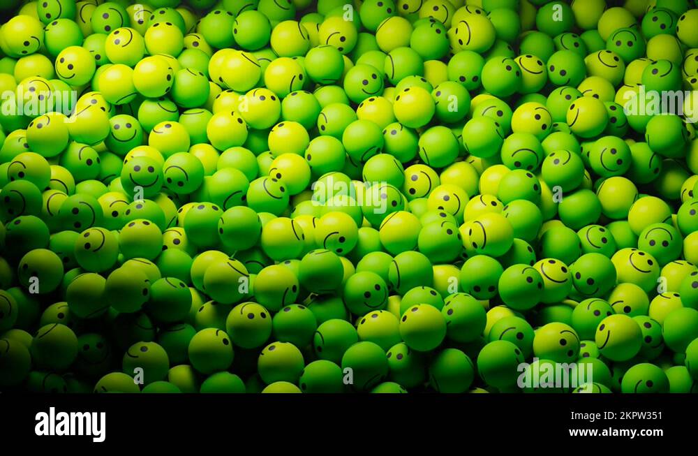 Seamless looping animation with many green balls with cute smiling ...