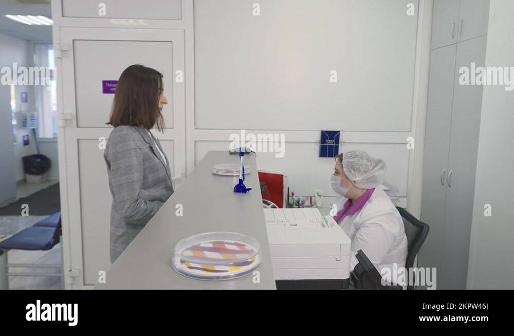 Patient being registered by the medical worker at the clinic reception ...