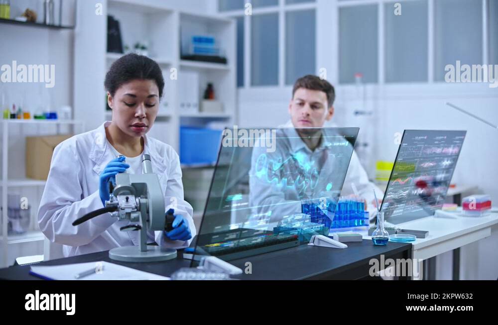 Black female scientist examining sample substance under laboratory ...