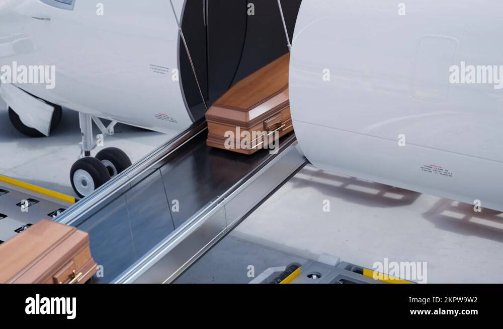 Coffins on the conveyor belt. Transport to the aircraft compartment ...