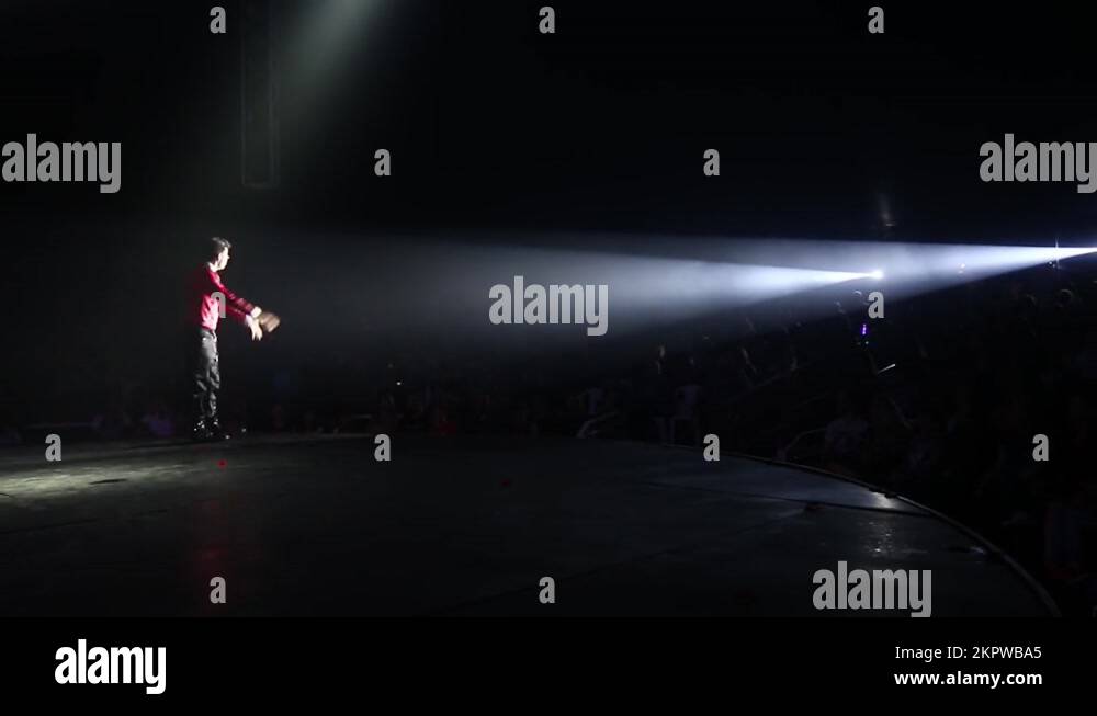 clown in the middle of the circus stage clapping and thanking the crowd ...