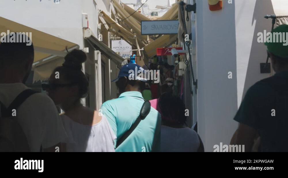 Thick crowd of tourists walking down a popular narrow path along ...