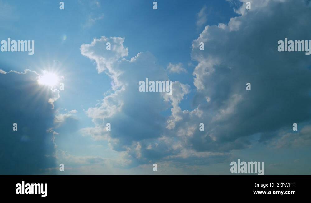 Rays of sun through clouds. Blue sky with cloudscape backlit bright ...