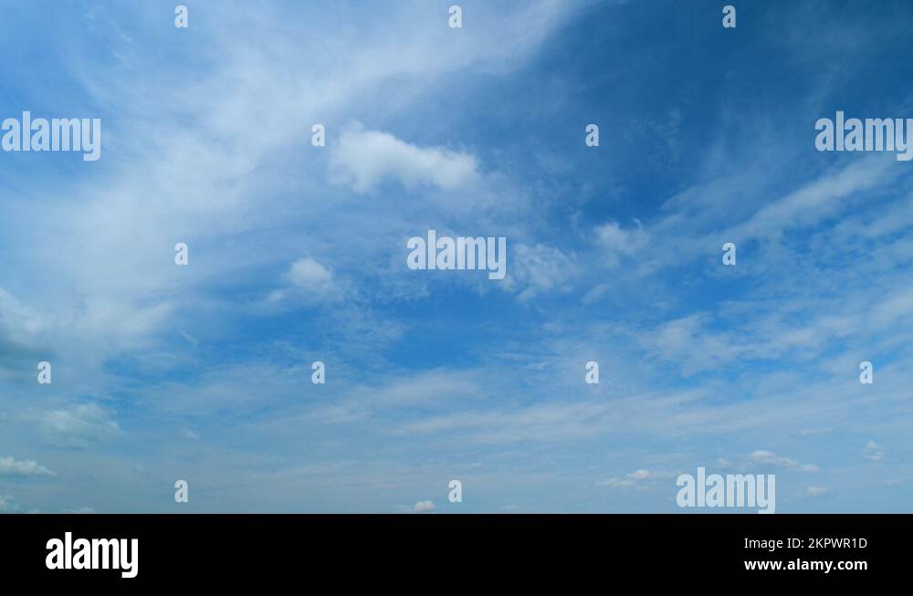 Floating fluffy clouds. Two layers of cloudiness. Blue summer sky with ...
