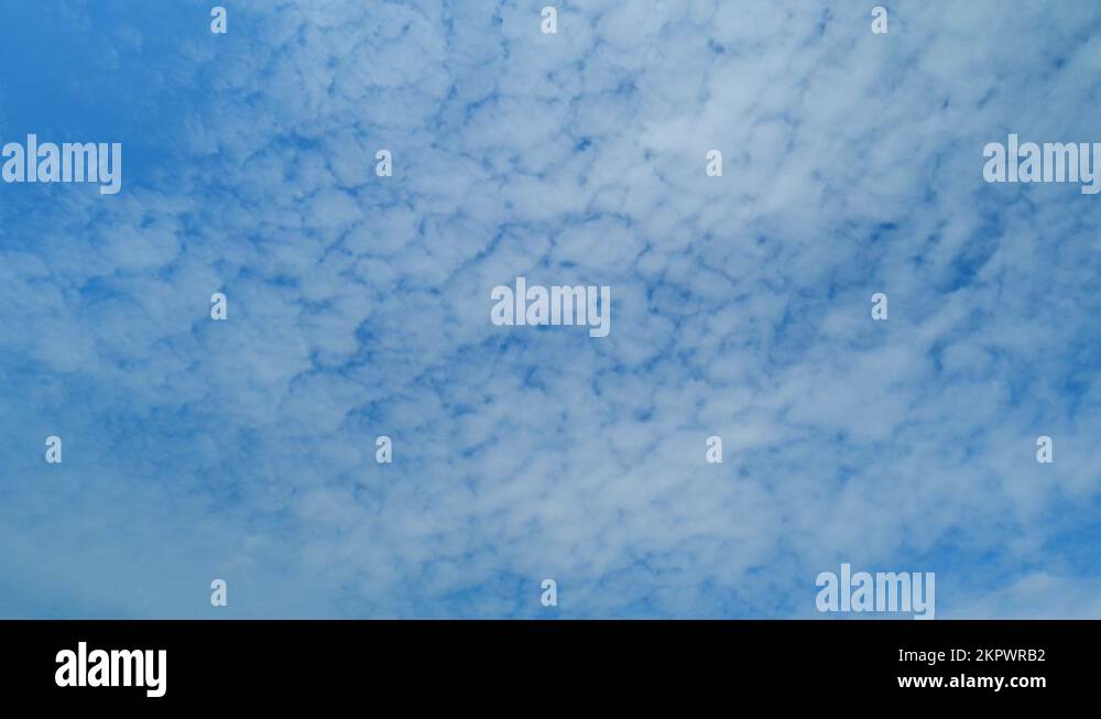 Light high clouds slide on sky. Layer of clouds in blue sky moving ...