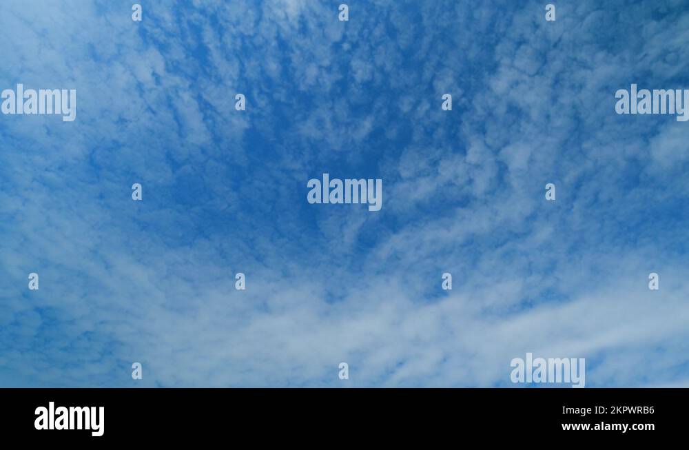 Floating fluffy clouds. Two layers of cloudiness. Blue summer sky with ...