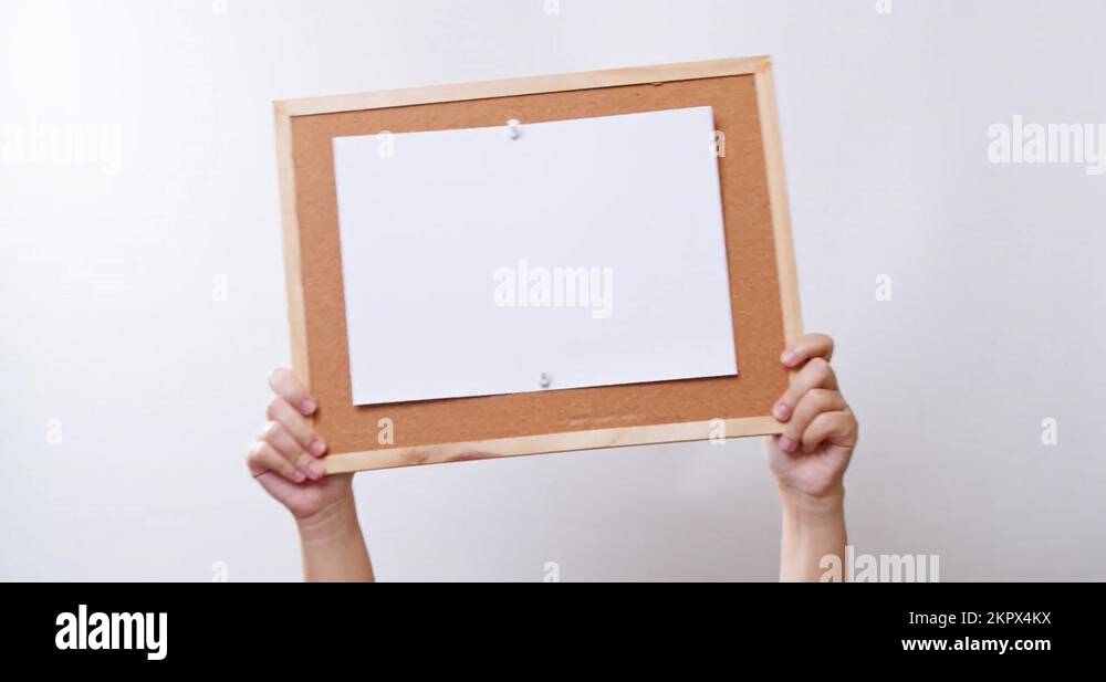 Woman's hand shows the paper on board in white studio background with ...
