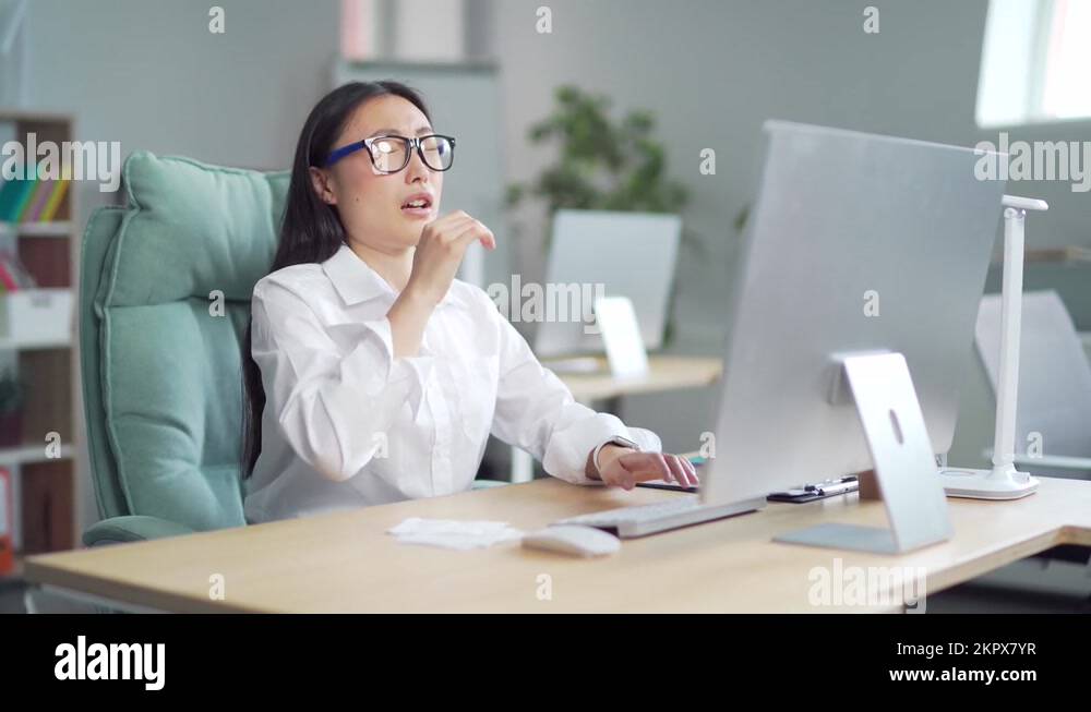 employee suffers from allergies in the office. Young worker sneezes at ...