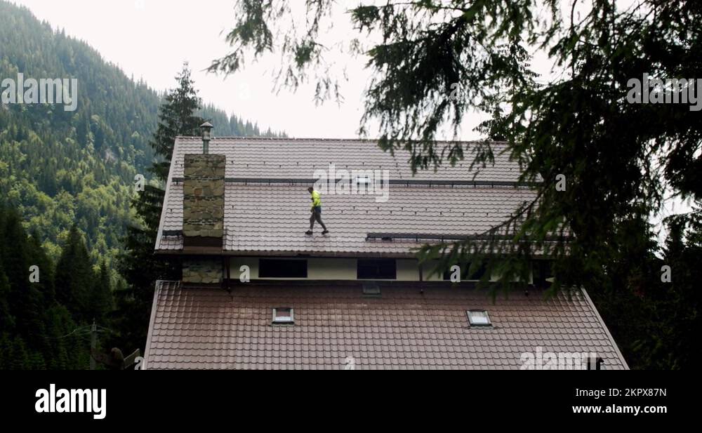 Man installer working on the roof of house. Tight Shot of Roofers ...