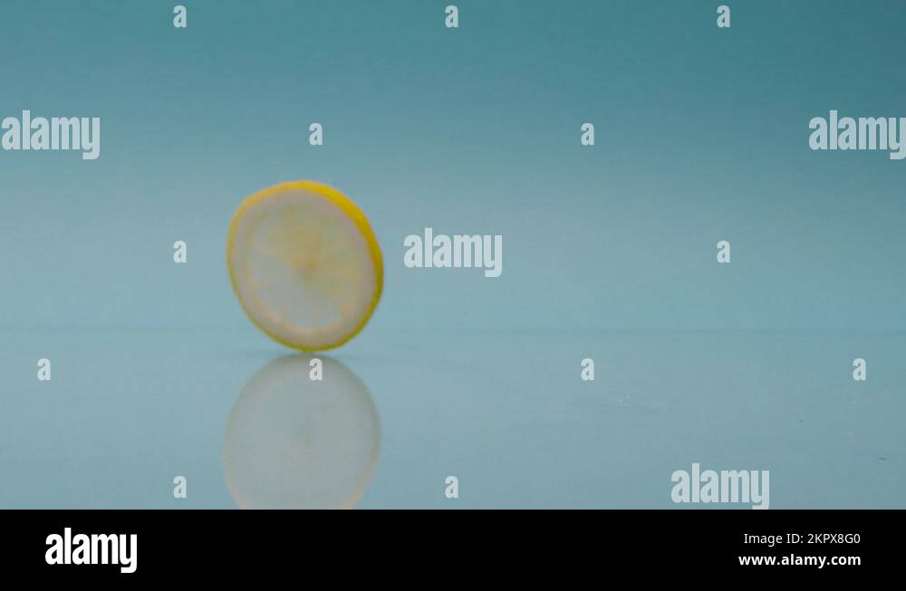 Slow Motion a Lemon Slice fall on blue background, Soft Drink with Lemon Stock Video Footage - Alamy