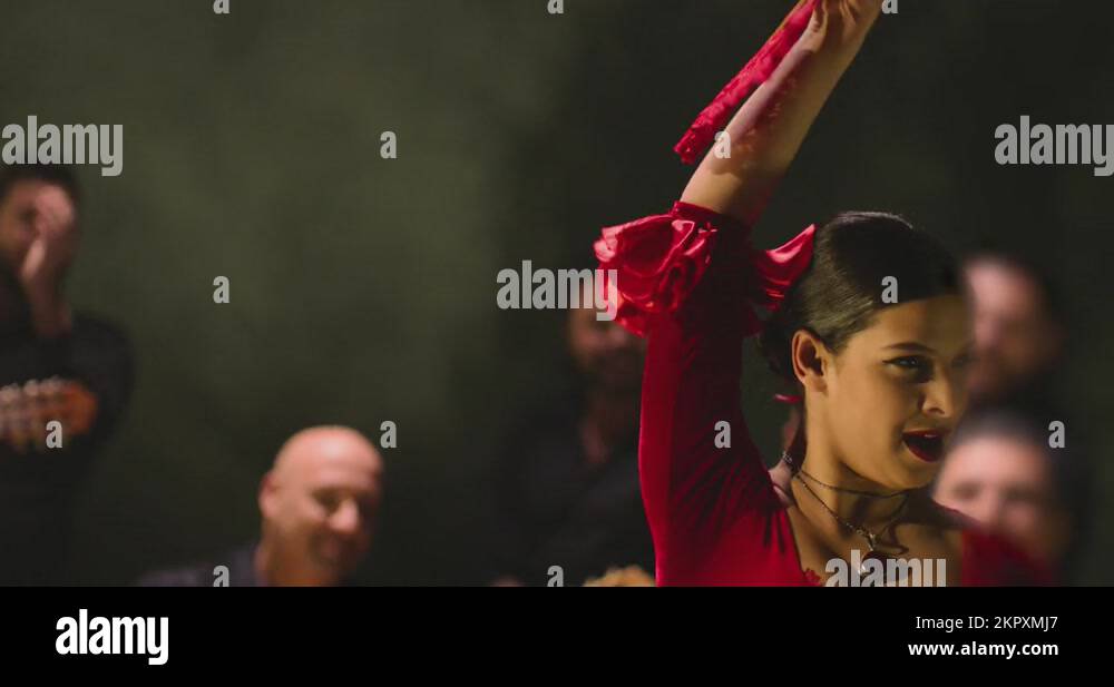 Woman dancing spanish style dance . Group of men playing on guitar and ...
