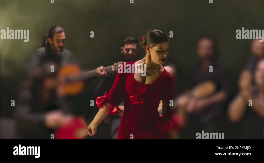 Woman dancing spanish style dance . Group of men playing on guitar and ...