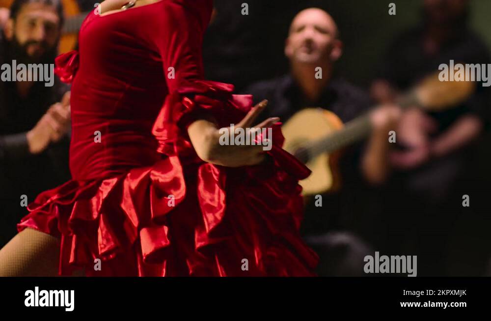 Woman dancing spanish style dance . Group of men playing on guitar and ...