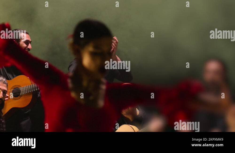 Woman dancing spanish style dance . Group of men playing on guitar and ...