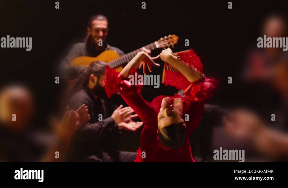 Woman dancing spanish style dance . Group of men playing on guitar and ...