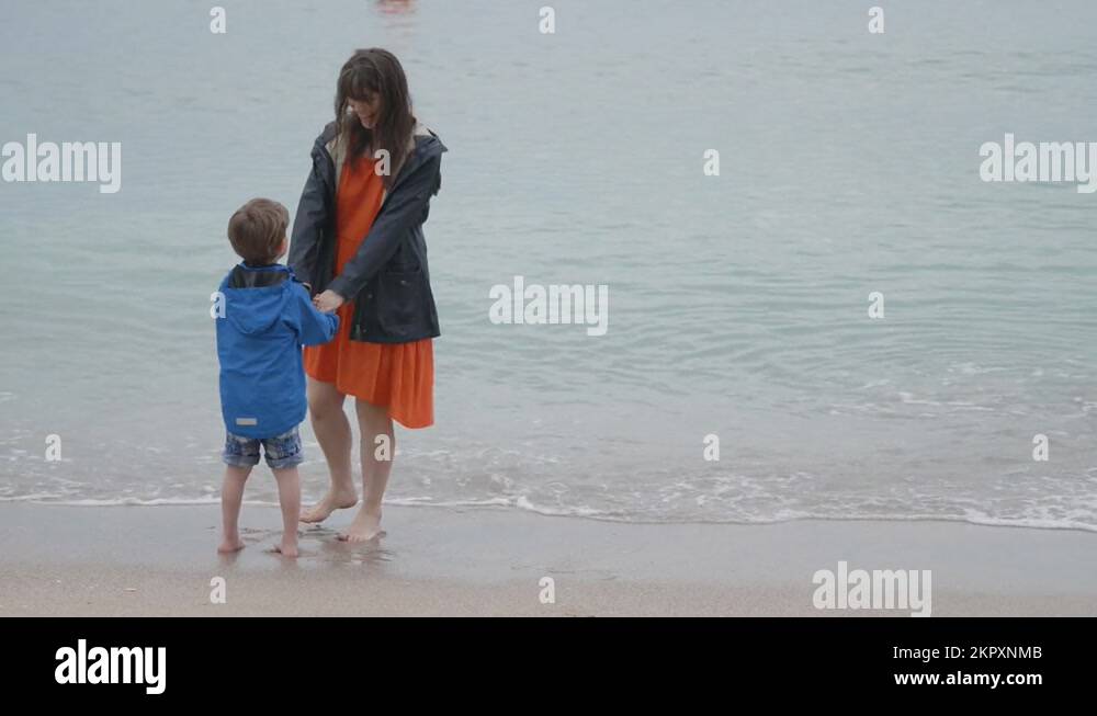 Mother and son playing game on beach, clapping hands Stock Video ...