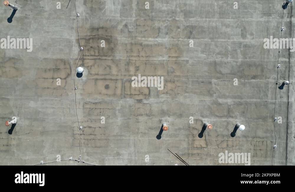 Drone aerial top down overhead of rooftop of abandoned warehouse ...