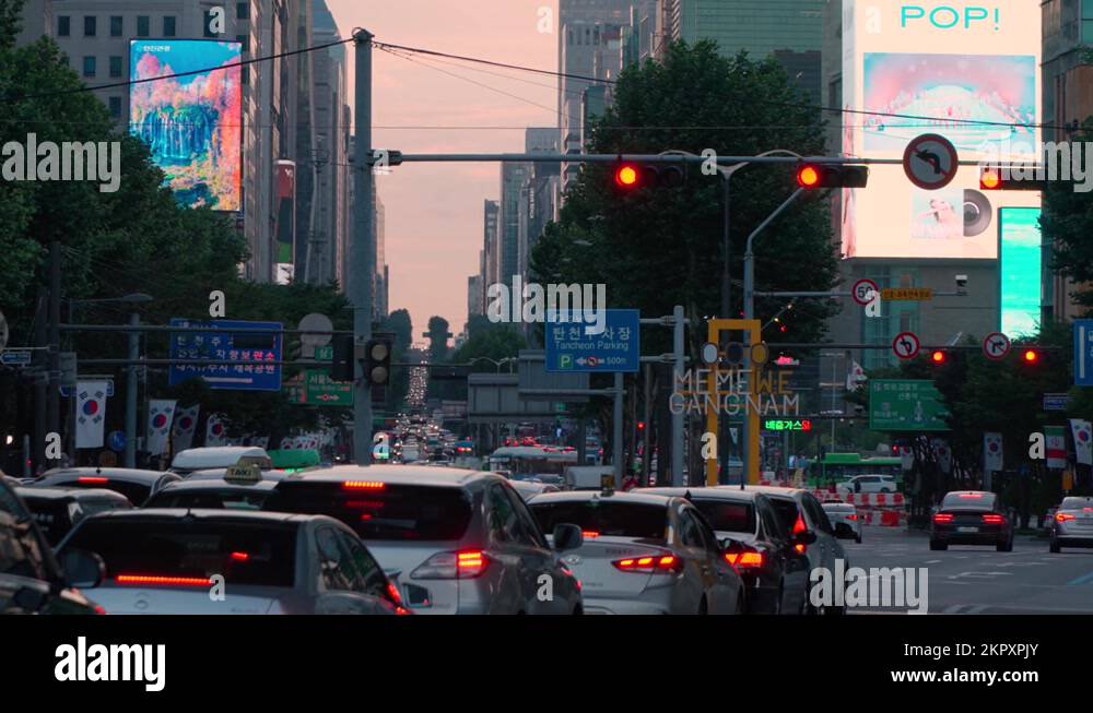 Traffic light signal change from red to green and cars start moving in ...