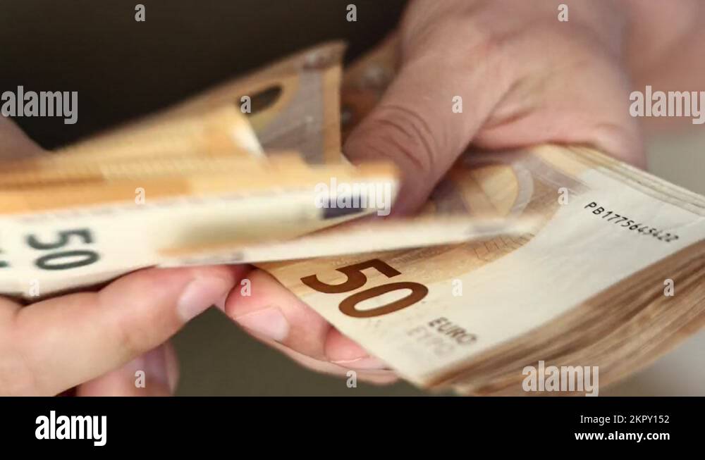 Man Counting Money. Close up of male hands counting big pile of 50 euro ...
