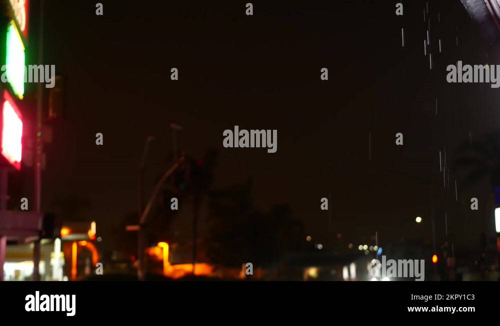 Rain drops drip from roof. Rainwater trickle at night. Rainfall on city ...