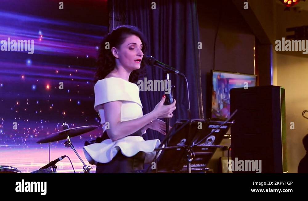 Singing woman with a microphone. Karaoke bar. professional singer Girl ...