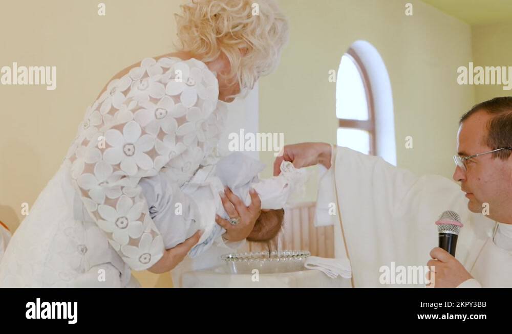 Newborn baby baptism in Holy water. Baptism in the font. Sacrament of Stock Video Footage - Alamy