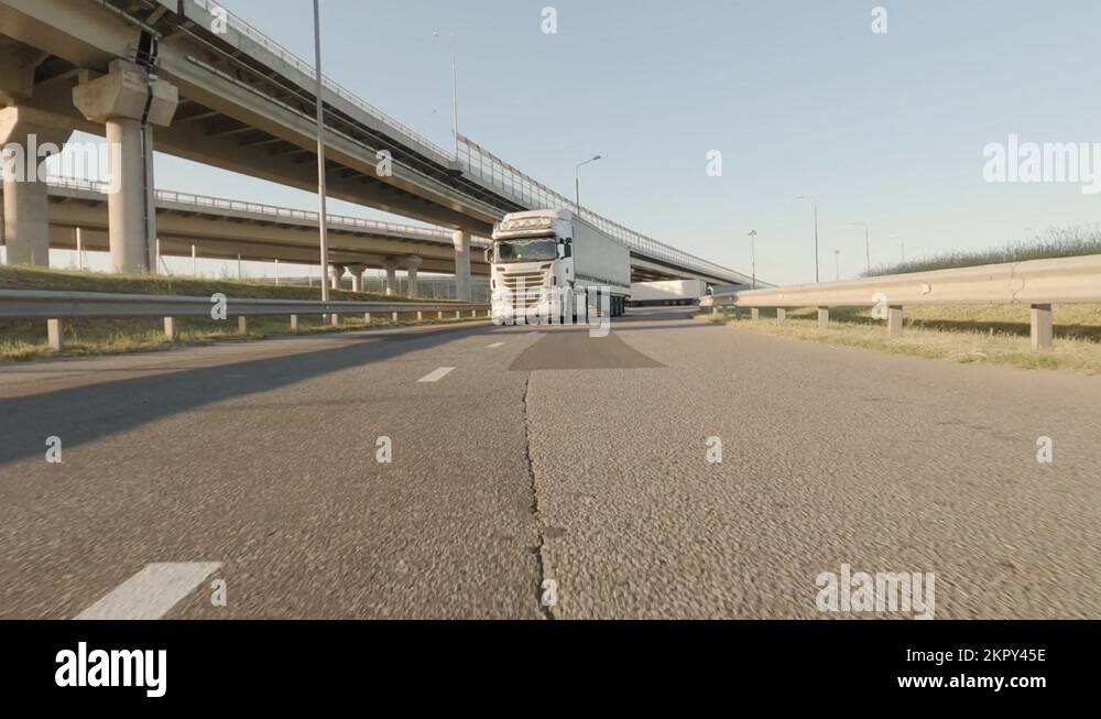 White Scania truck tractor semi-trailer truck driving on road front ...