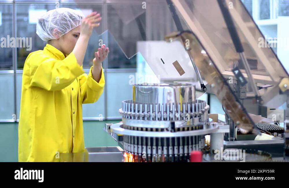 Female Production Line Worker Operates The Machine At Pharmaceutical ...