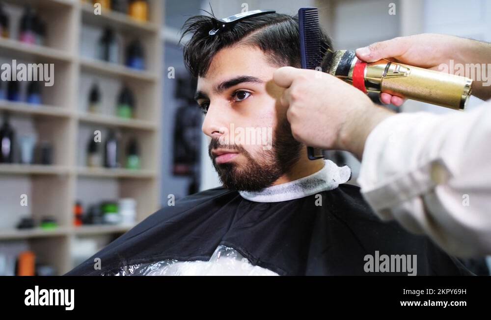 Barber haircut hair using electric trimmer, barber makes haircut for ...