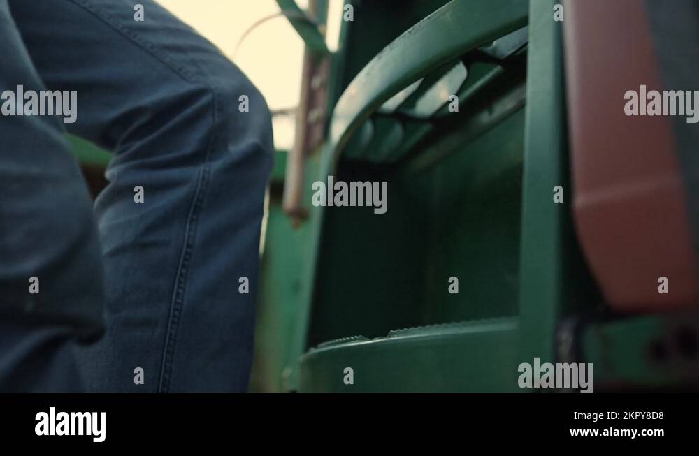 Man legs step tractor ladder sunrise closeup. Farmer go cabin before ...