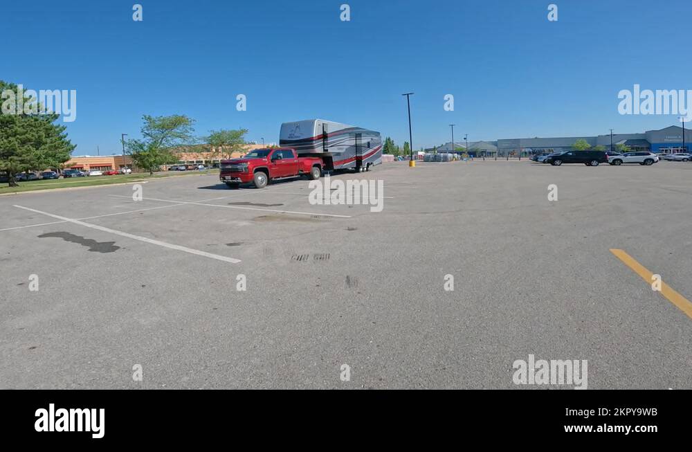 POV driving through a big box store's parking lot and pull up next to a ...