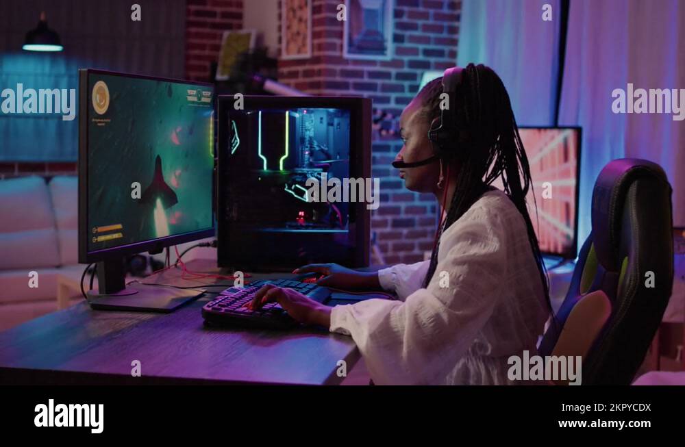 African american gamer girl using pc gaming setup playing multiplayer ...