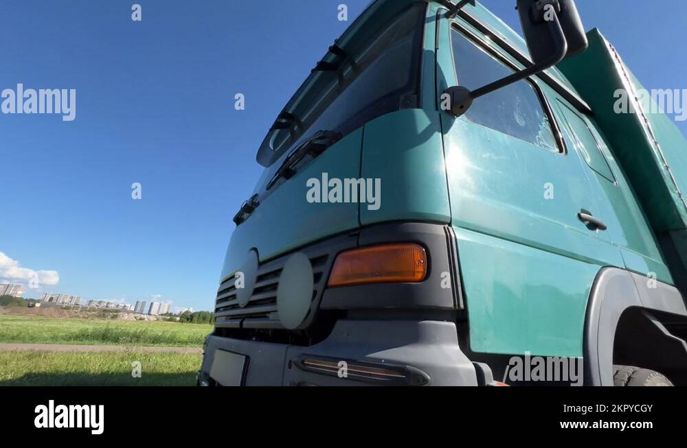 Green semi-trailer truck is parked in logistics park waiting to unload ...