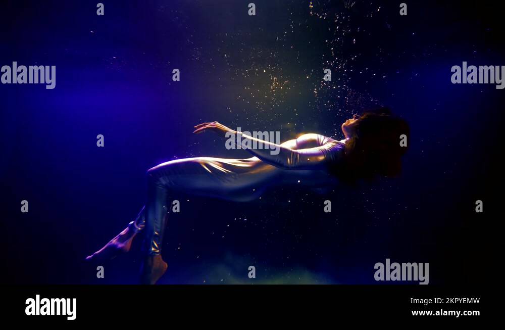 underwater unreality, woman is floating in amazing dark depth, lady in ...