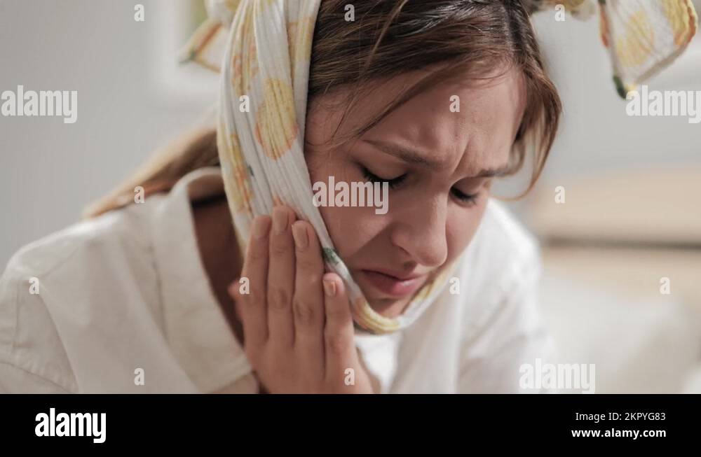 Toothache, pain in tooth. Suffering woman with bandage on her face ...