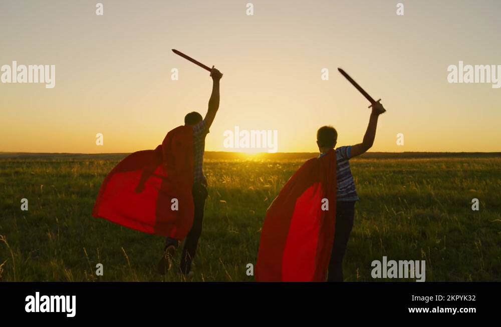 Dad and son playing superhero. Child, father waving a toy sword ...