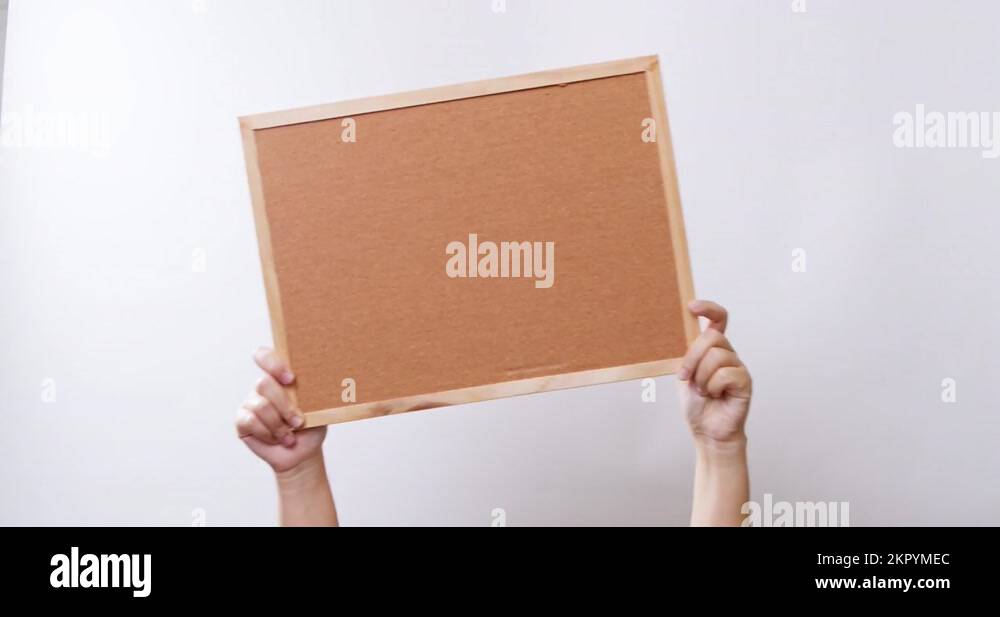 Woman's hand shows the empty board in white studio background with copy ...